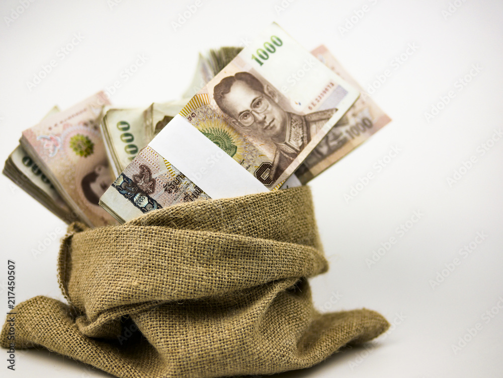 stacks of Thai Baht money in sack bag isolated on white background ...