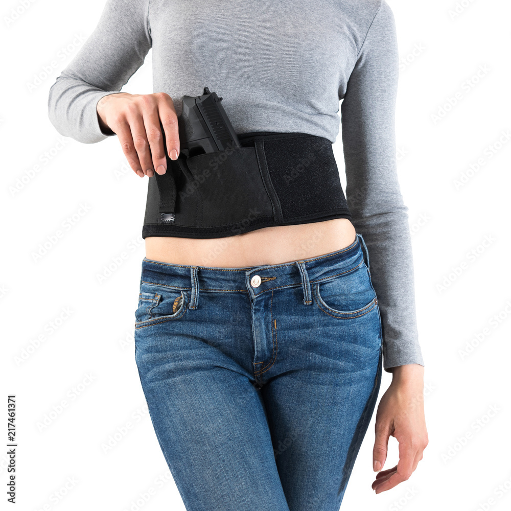 Killer holding a gun to his feet, white background in front of him ...