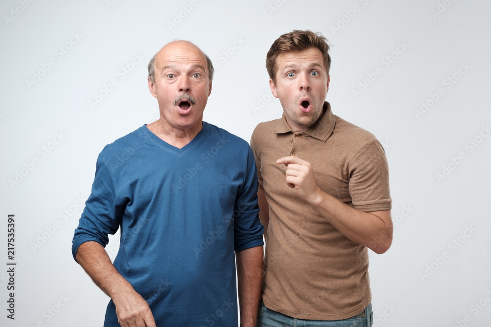 Frightened two men have scared expressions, look nervously, isolated ...