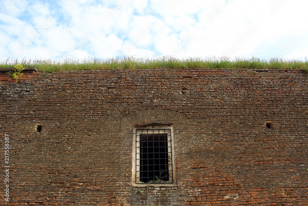 Prison cell wall with a window with bars Stock Photo | Adobe Stock