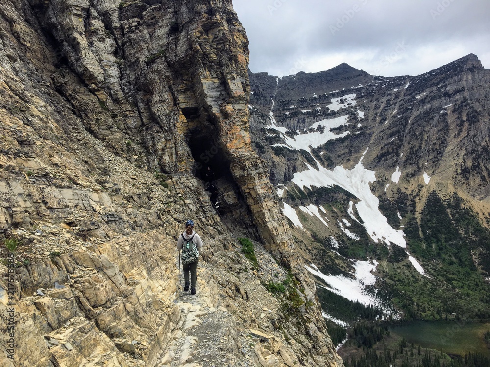 Hiking near the steep edge of a cliff while hiking the Crypt Lake Trail ...