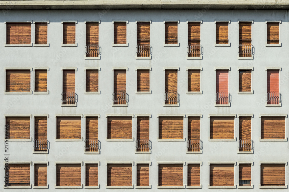 Concrete facade with series of facade of windows and small ...