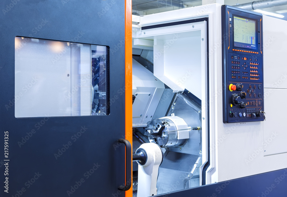 The CNC lathe machine or Turning machine drilling the metal rod with ...