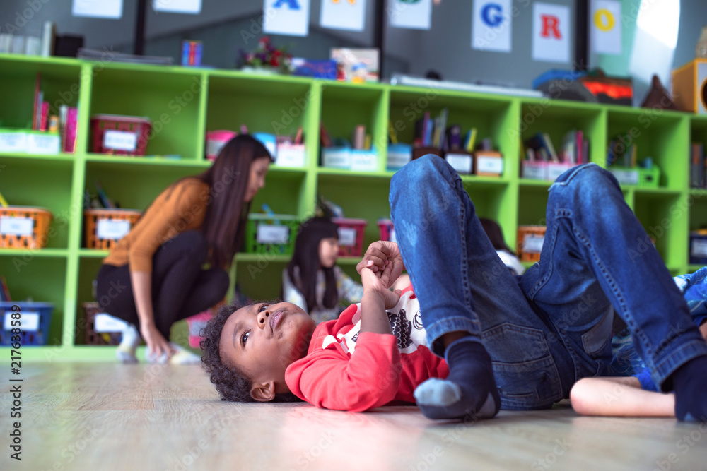 A stubborn intractable and naughty boy kids in classroom at ...