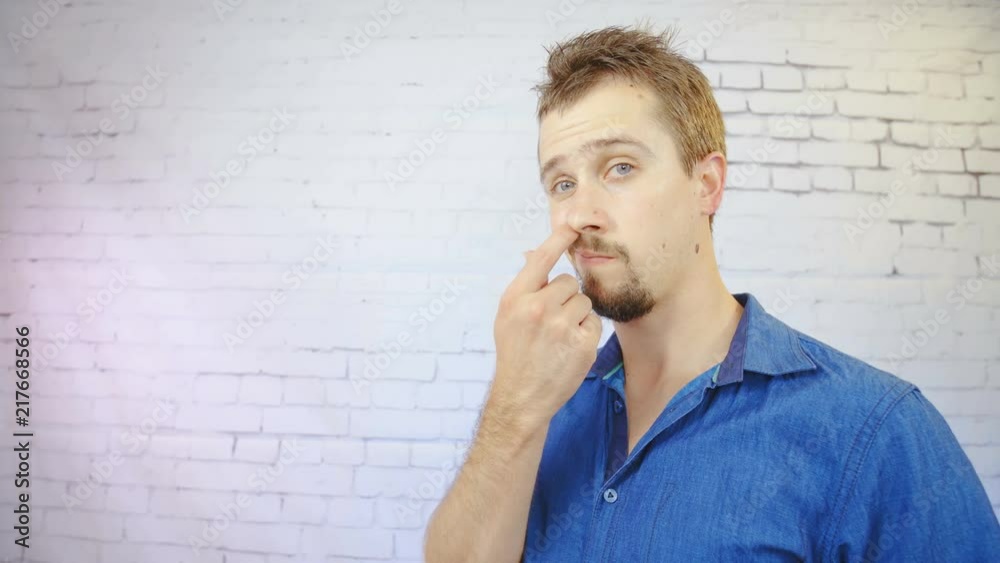 Gold digging from nose with finger slow motion 4K. Static portrait of a ...