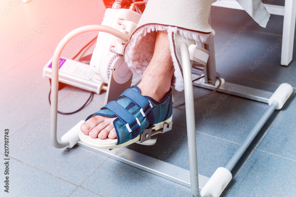 Patient on CPM (continuous passive range of motion) machines. Device to ...