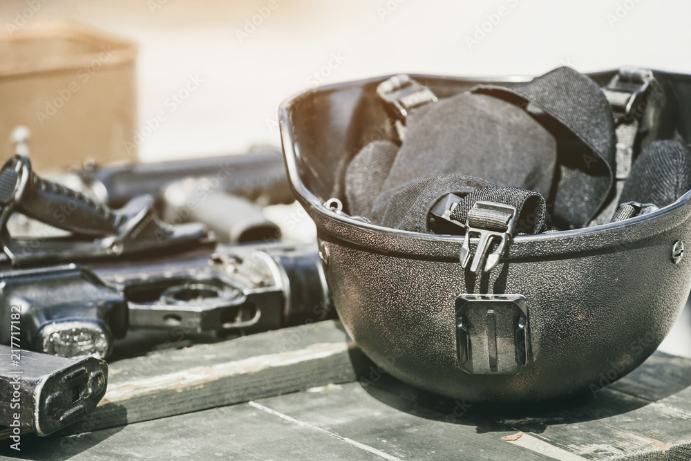 The machine, machine gun, army helmet with a flashlight lying in a pile ...
