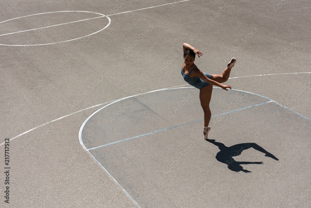 Female ballet dancer dancing in the basketball court Stock Photo ...