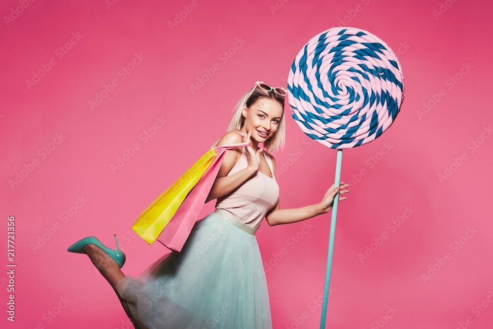 Beautiful model with sweets at pink background Stock Photo | Adobe Stock