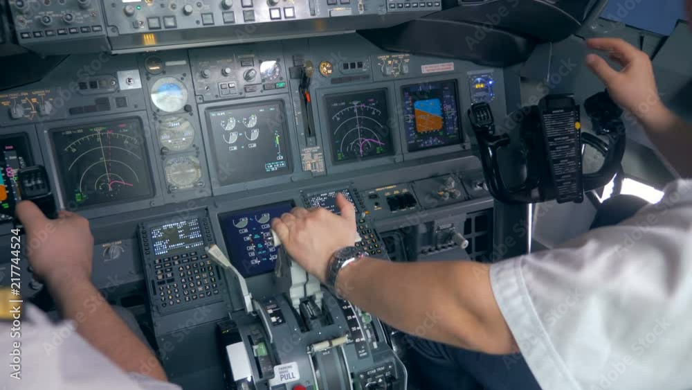 Airplane interior. Hand of pilot push thrust lever handle for engine ...