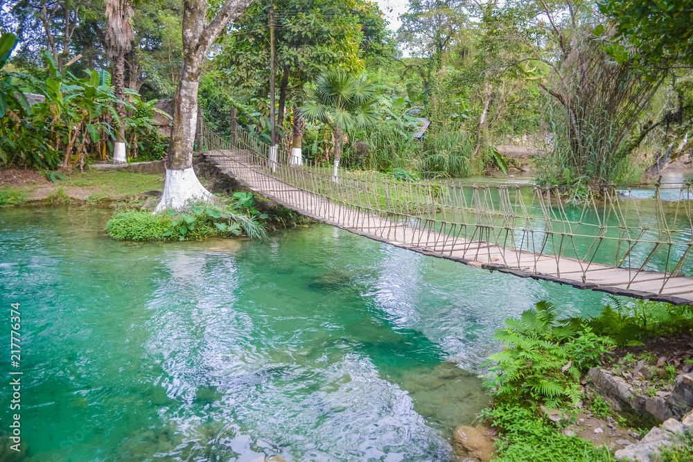 Suspended bridge and amazing crystalline blue water of Tamasopo river ...