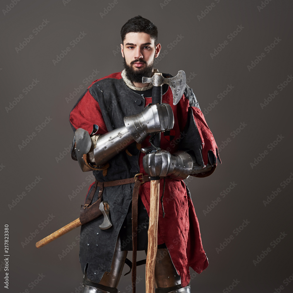 Medieval knight on grey background. Portrait of brutal dirty face ...