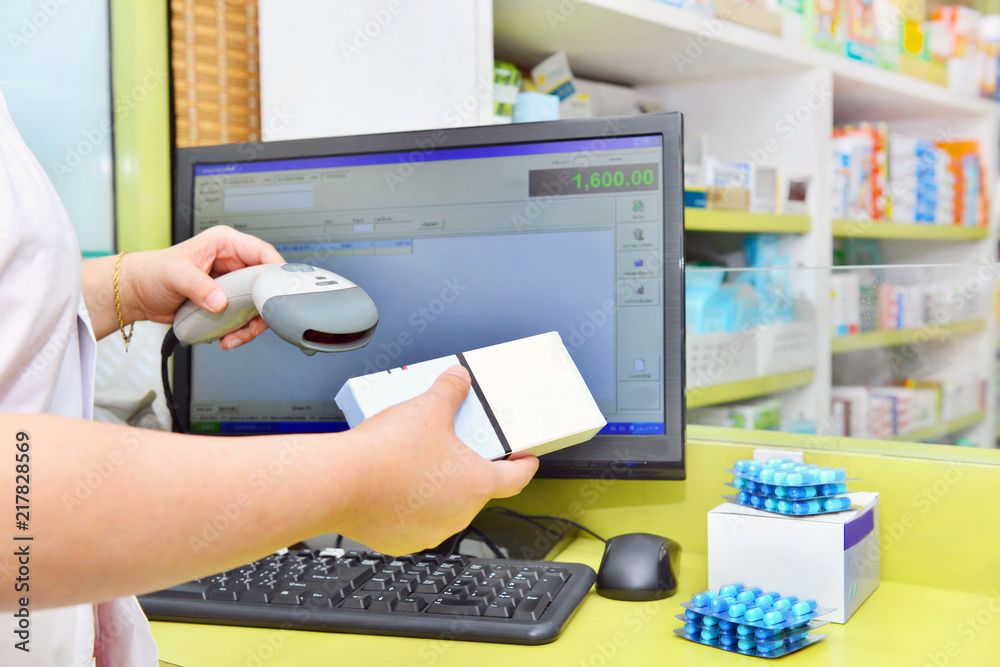 Pharmacist scanning barcode of medicine drug in a pharmacy drugstore ...