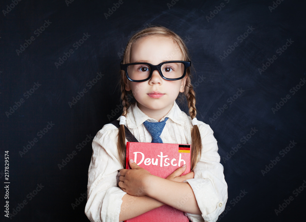German language concept. Cute kid schoolgirl in classroom against ...