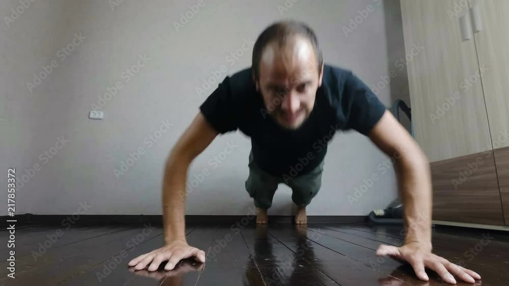 the guy pushed off the floor with a strained tired face. young man ...