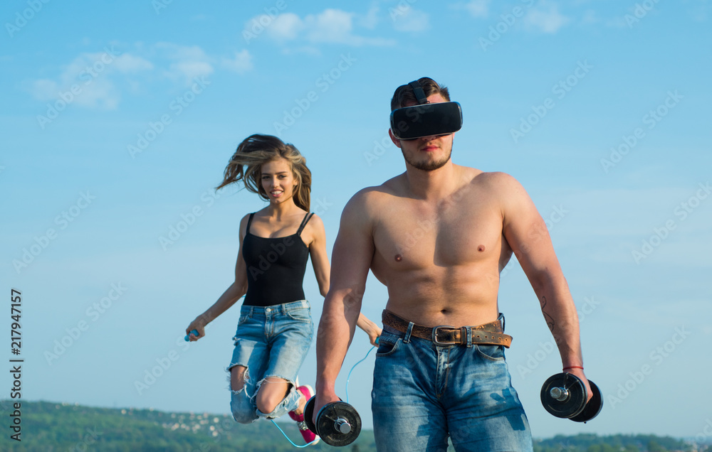 Strong man with musucular torso and fit woman skipping. Strong ...