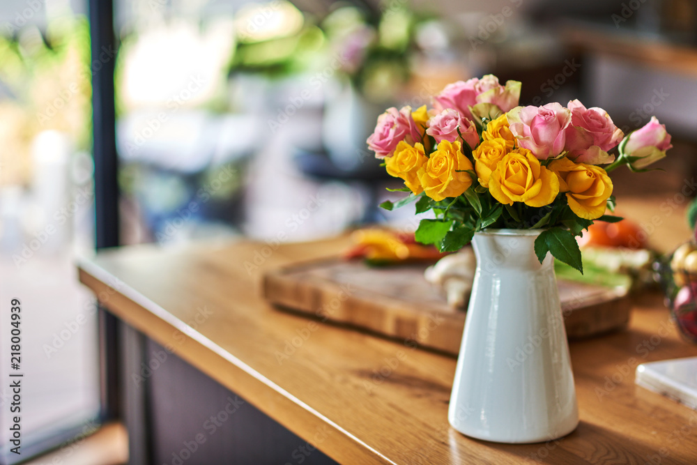 Yellow and pink roses on kitchen background. Stock Photo | Adobe Stock
