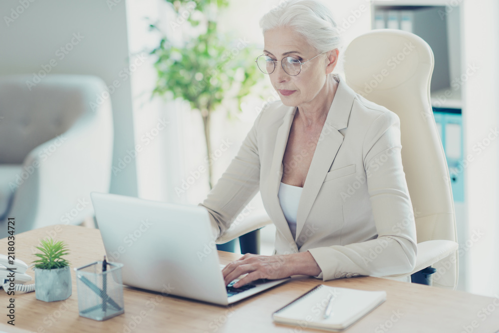Mature focused old lady business woman in white formal clothes w Stock ...