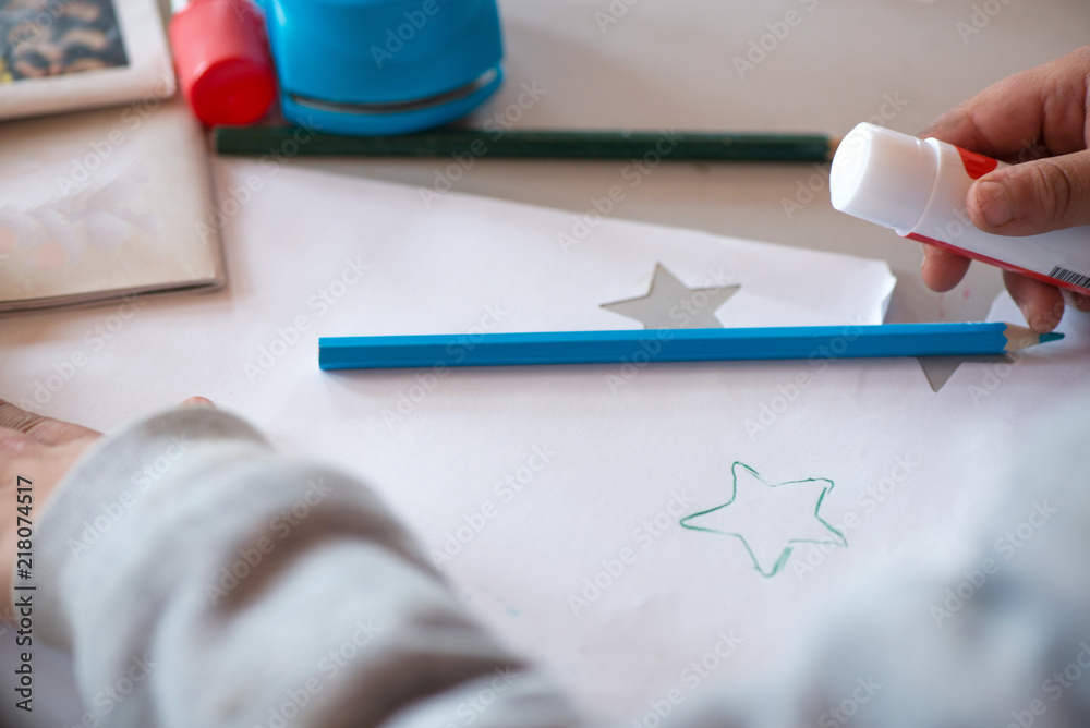 Creative workshop for kids. Little girls gluing cut out shapes and ...