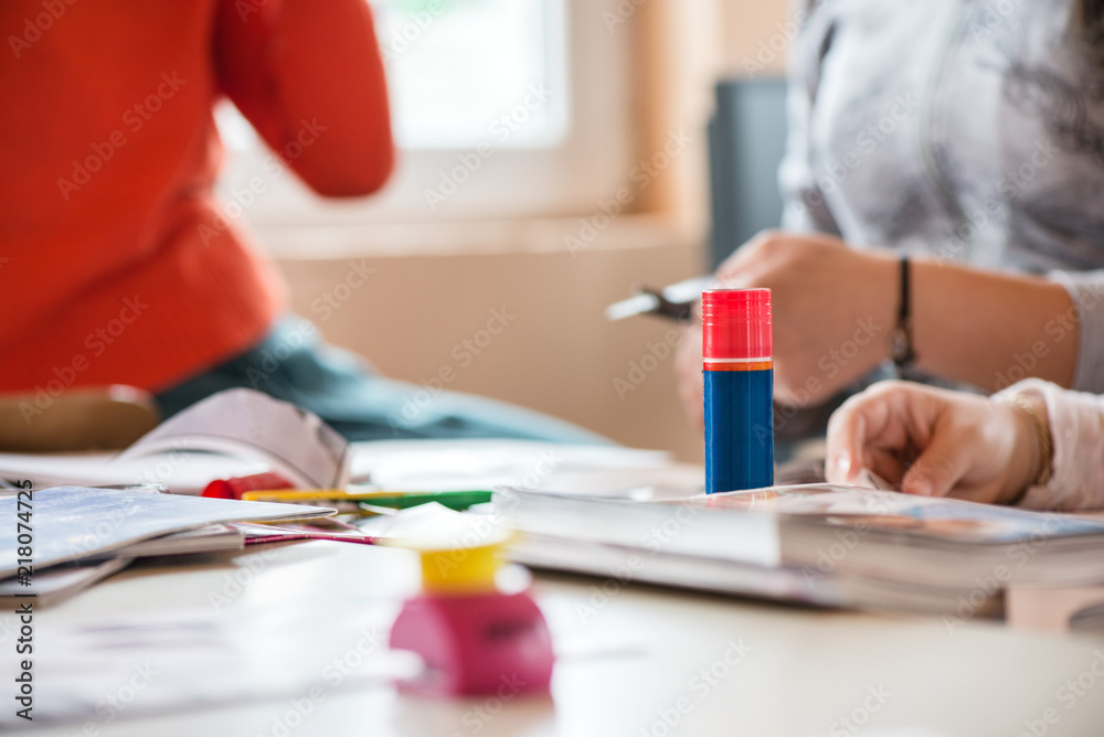 Creative workshop for kids. Little girls gluing cut out shapes and ...