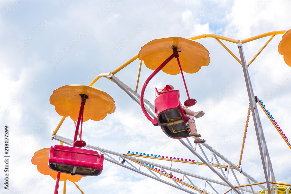 Colorful roller coaster seats at amusement park. People having fun in ...