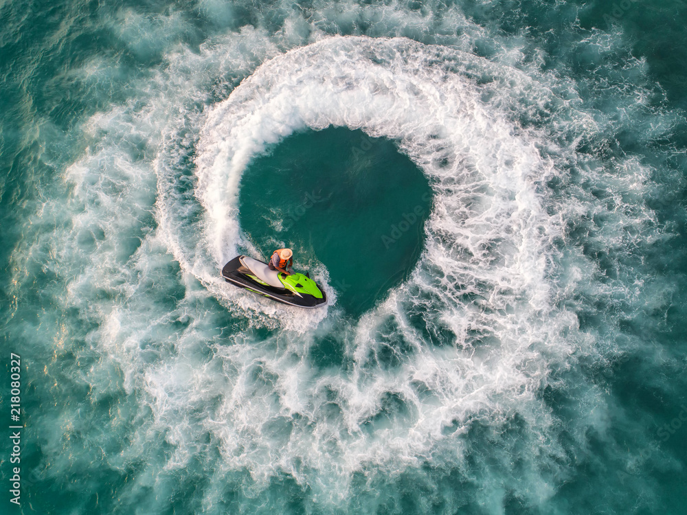 People are playing jet ski at sea during the holidays. Aerial view and ...