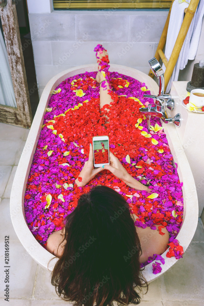 The girl takes a flower fragrant very beautiful bath.Woman relaxing in ...