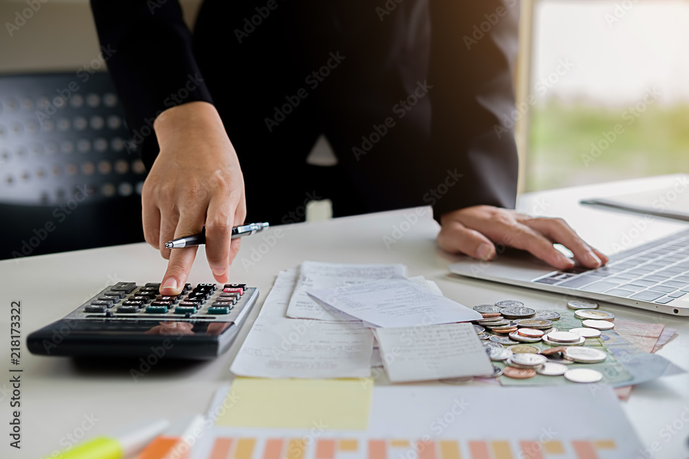 Woman with bills and calculator. Woman using calculator to calculate ...