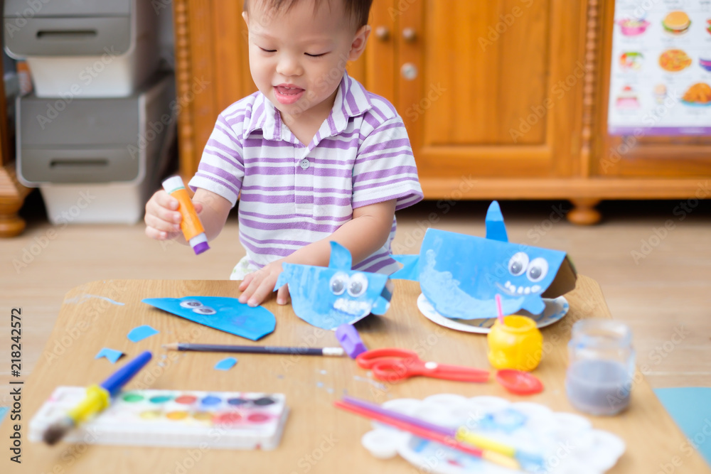 Happy cute little Asian 2 years old toddler boy child enjoying doing ...