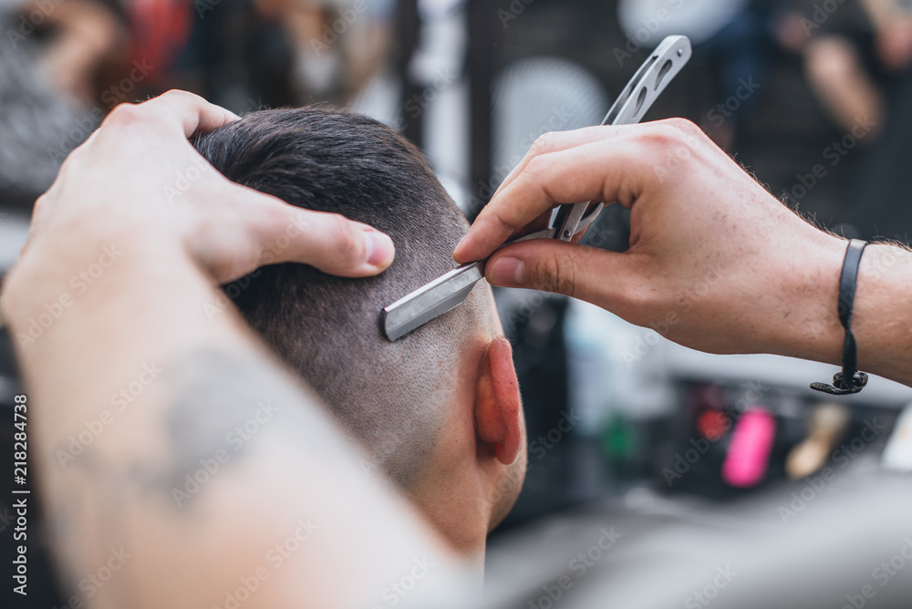 Barber makes an ideal hairstyle. Haircut Fade. Hairdresser performs a ...