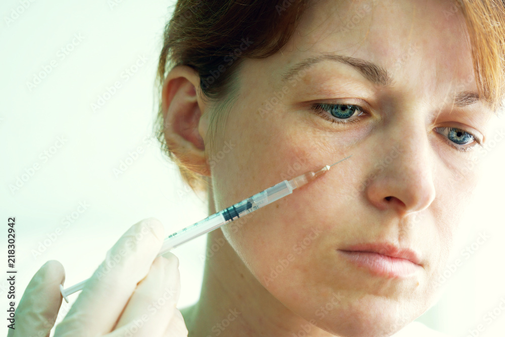 the girl with blue eyes doctor cosmetologist makes injections in the ...