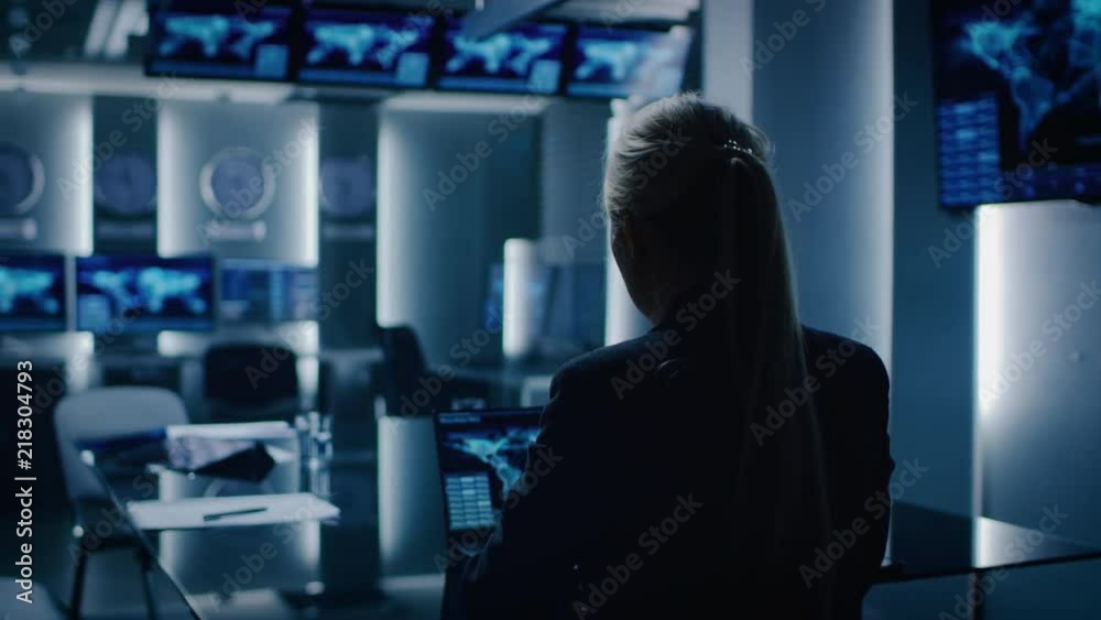 Female Special Agent Works on a Laptop in the Background Special Agent ...