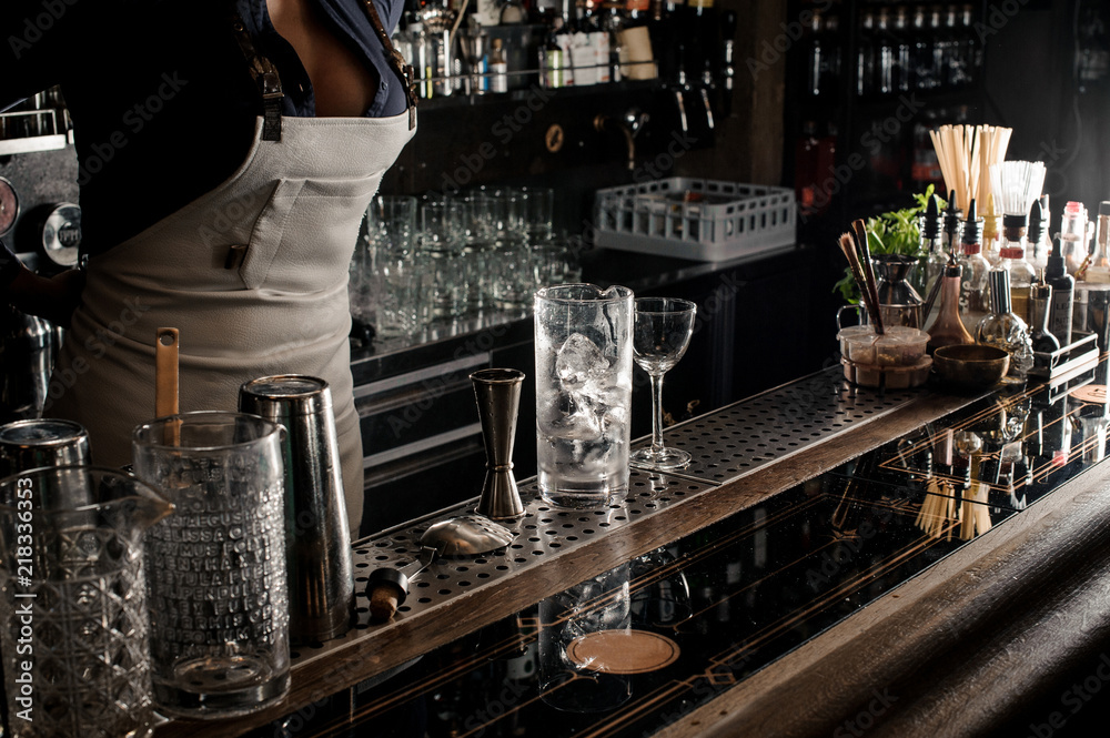 Sexy female barman with decolletage standing behind the bar counter ...