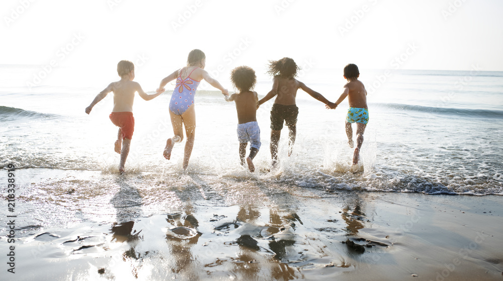 Group of kids enjoying their time at the beach Stock Photo | Adobe Stock