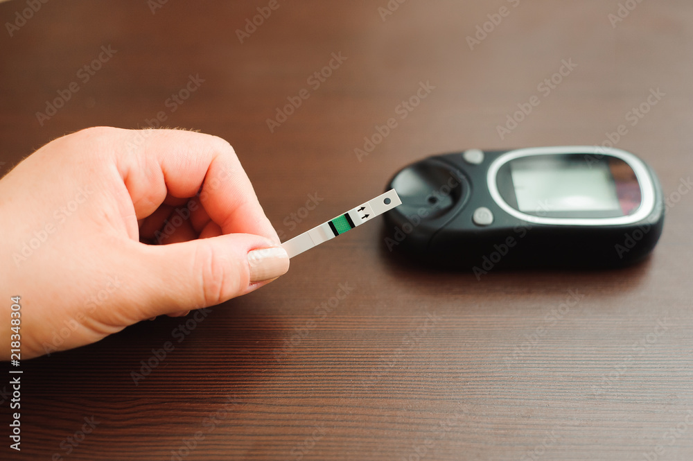 Diabetic patient doing glucose level blood test using ultra mini ...