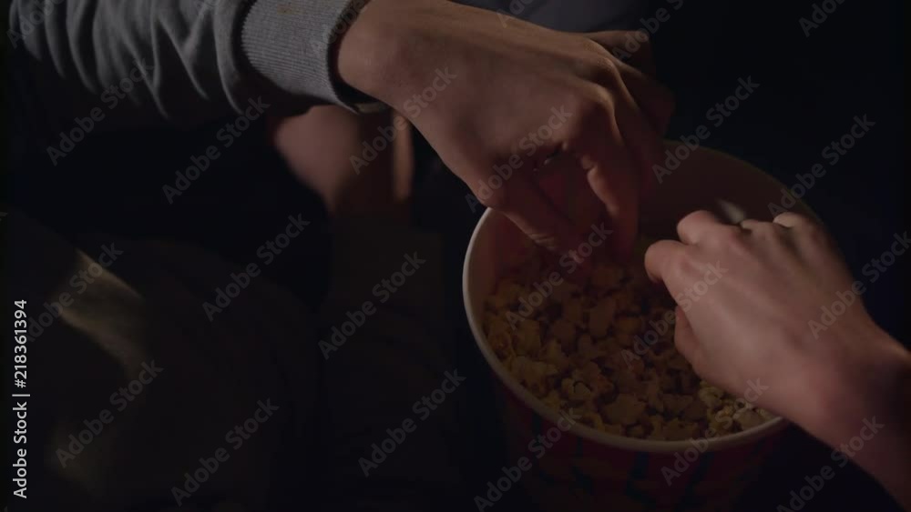 Vídeo do Stock: Female and male hand take popcorn grains from popcorn ...