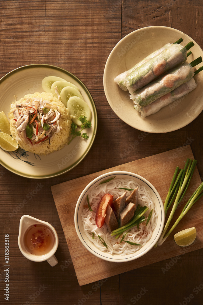 Assorted asian dinner, vietnamese food. Chicken rice, bun cha ca ...