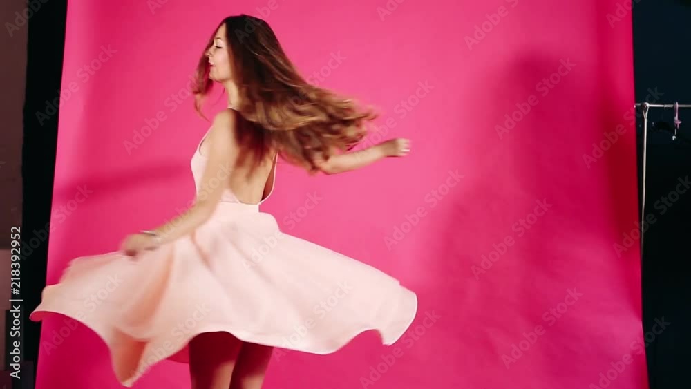 Charming and attractive young girl wearing trendy pastel pink dress ...