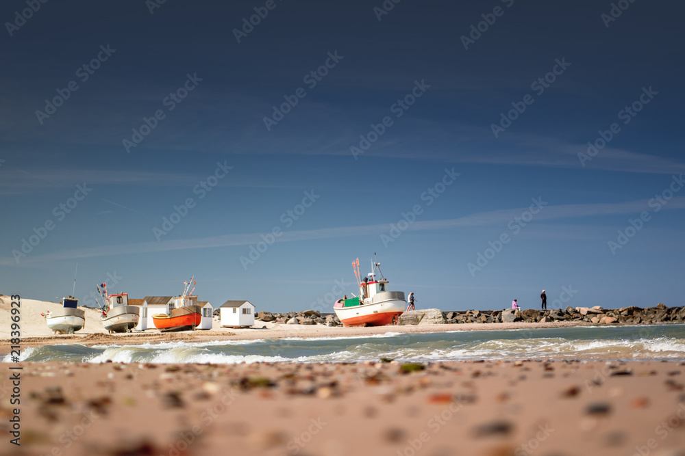 Colorful small fishing boat on the shore beach of danish north sea ...