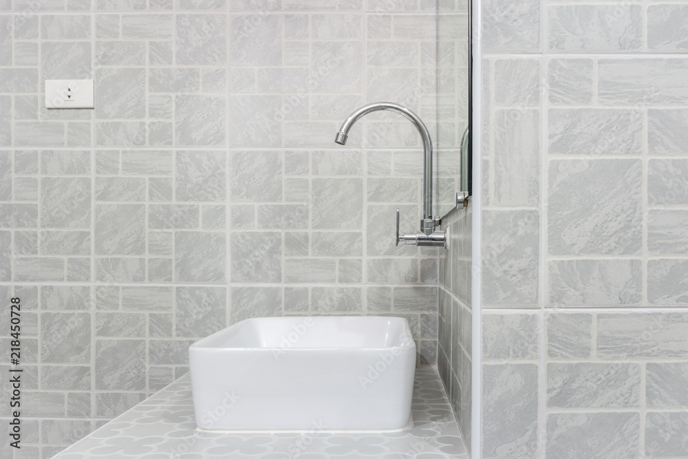 Side view of new modern grey restroom. It consists of mirror, ceramic ...