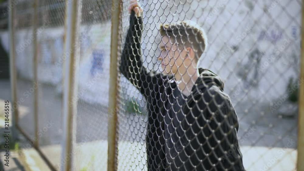 Teen boy behind fence confinement, boarding school restrictions, broken ...