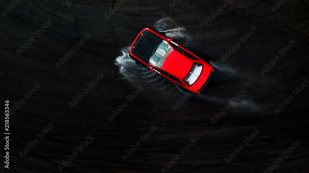 Aerial top view professional driver drifting car on wet race track ...