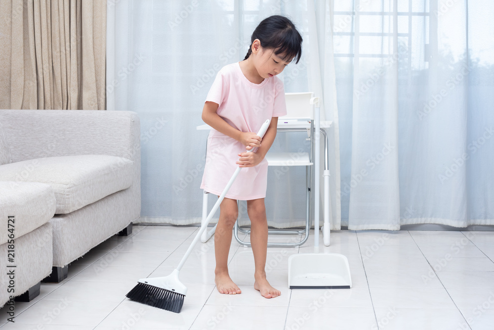Asian Chinese little girl helping doing cleaning with broom and dustpan ...