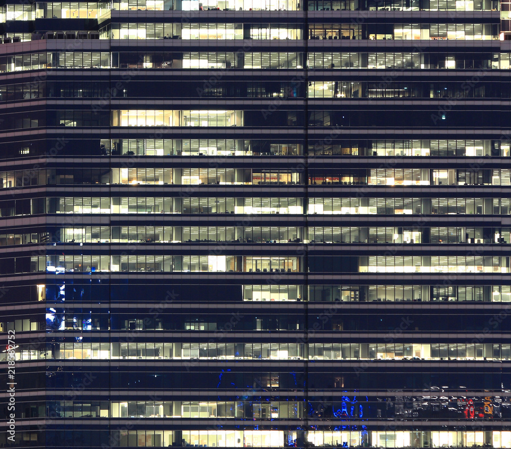 stacked floor office. night time light emmitted from modern curtain ...