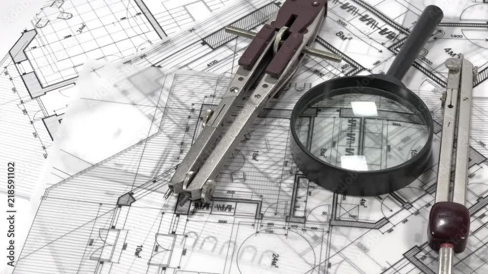 Blueprints - rolls of architectural drawings, loupe - magnifying glass ...