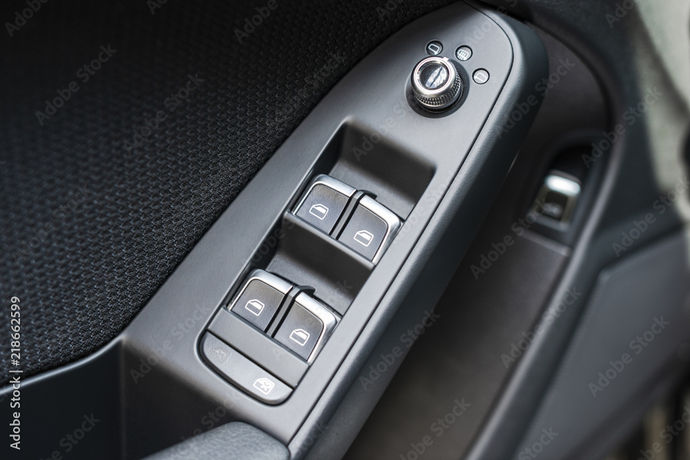 Door handle with Power window control buttons of a luxury passenger car ...