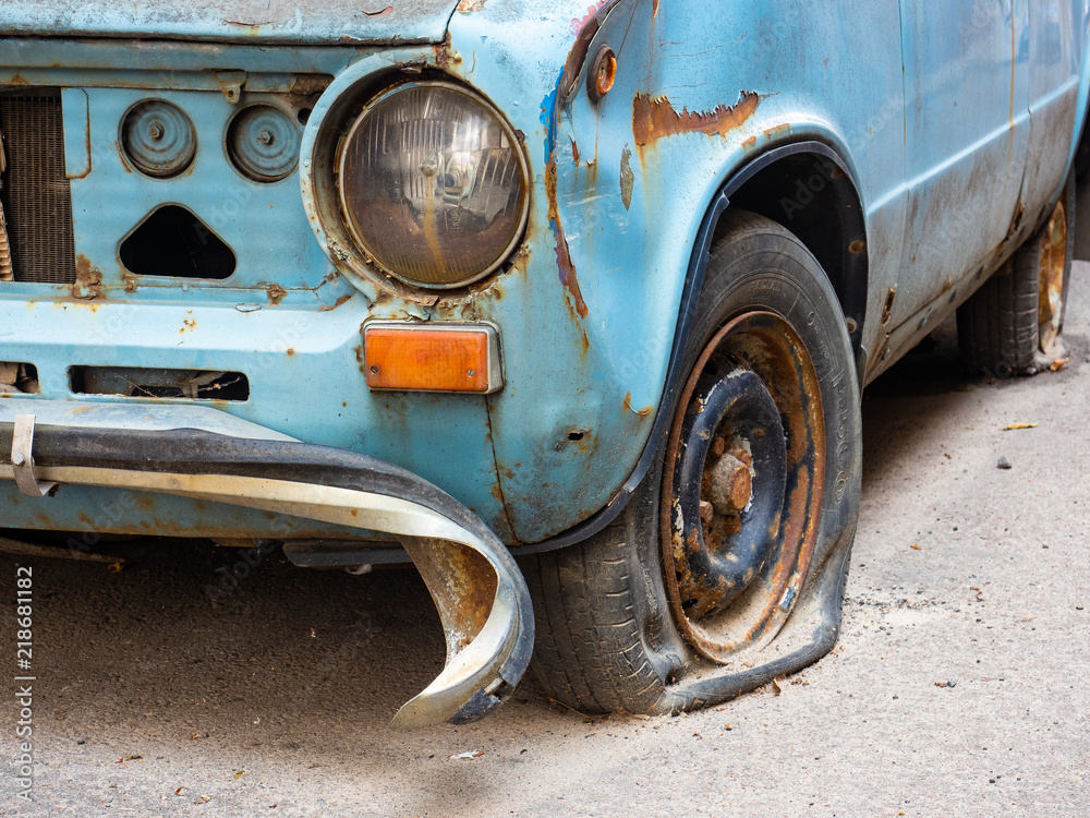 Close-up of an abandoned and Rusting Soviet Lada Car with a flat tyre ...
