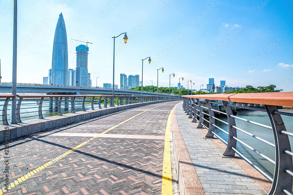 Curved road surface bridge pavement under blue sky and white clouds ...