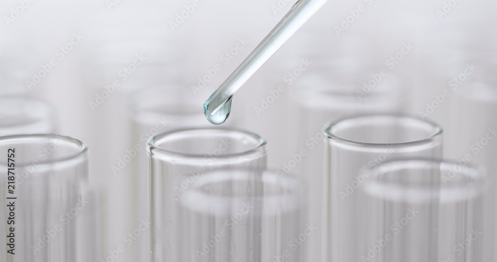 Pipette drip drop into a test tubes Stock Photo | Adobe Stock