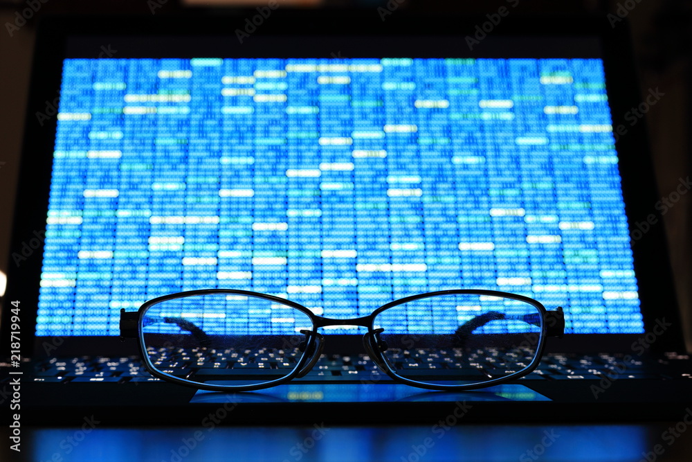 Glasses in front of laptop monitor. digital screen displayed blue light ...